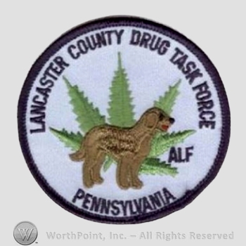 Mark with The text "LANCASTER COUNTY DRUG TASK | #935378